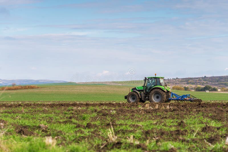Tractor plowing fields stock photo. Image of farmland - 174266960