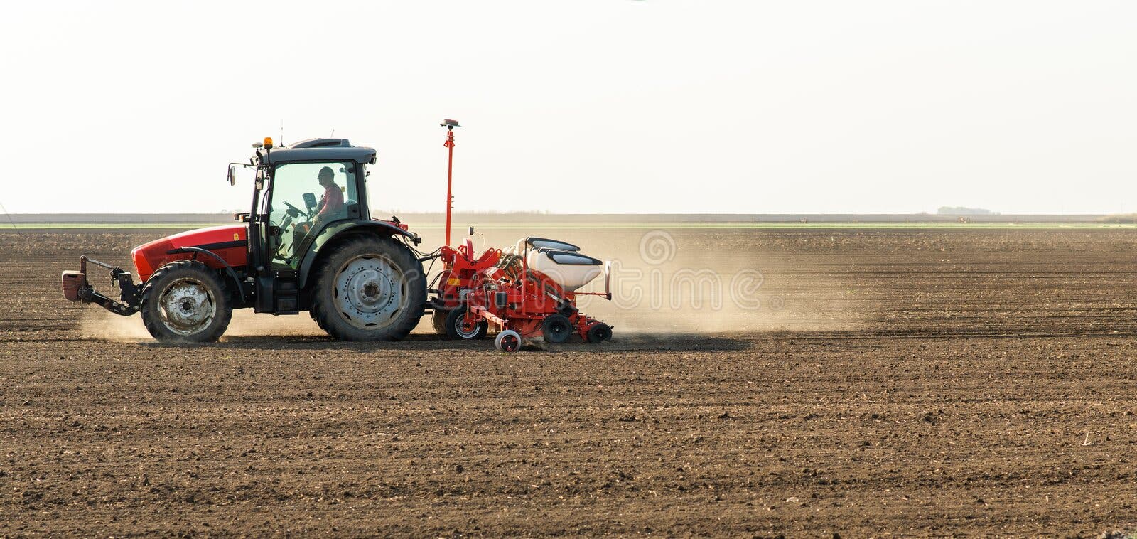 Farmer with Tractor Seeding - Sowing Crops at Agricultural Field Stock ...