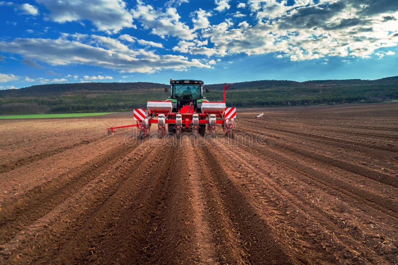 Farmer with Tractor Seeding Crops at Field Stock Image - Image of ...
