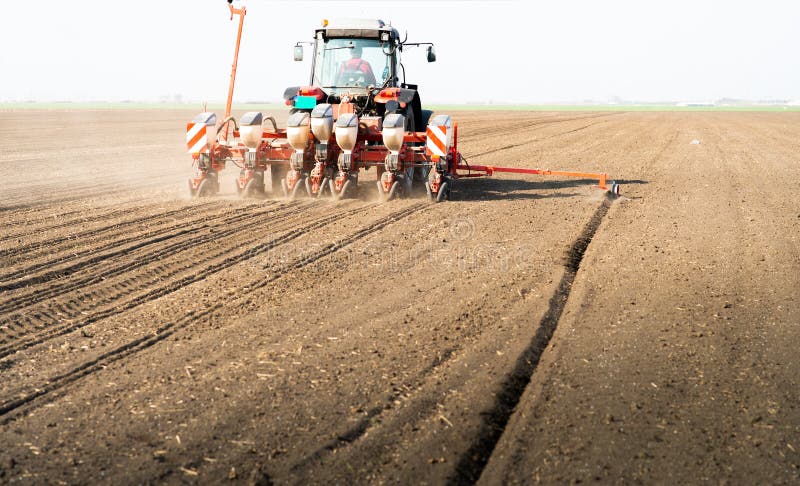 Farmer with Tractor Seeding Sowing Crops at Agricultural Field Stock ...