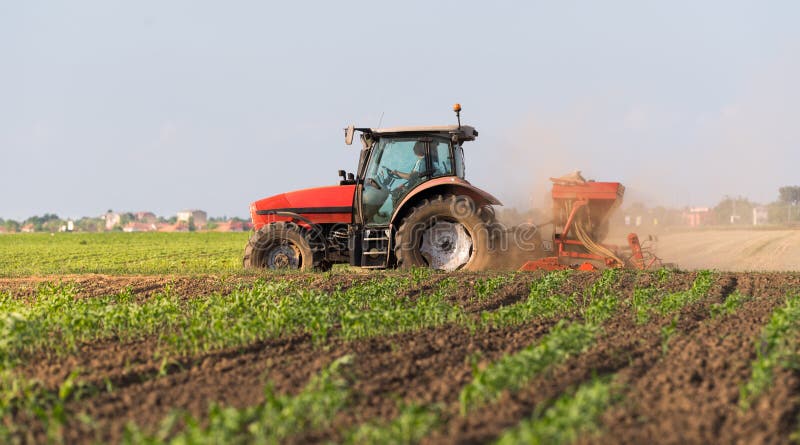 Farmer with Tractor Seeding - Sowing Crops at Agricultural Field Stock ...