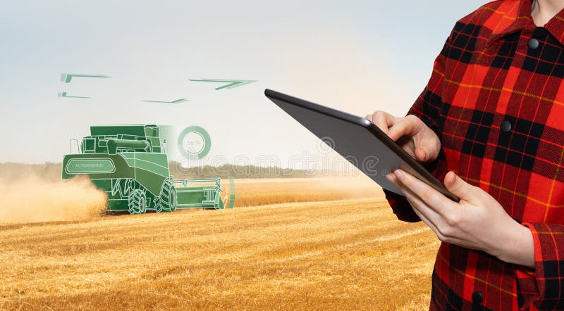 Farmer Uses a Digital Tablet To Control Autonomous Harvester. Stock ...