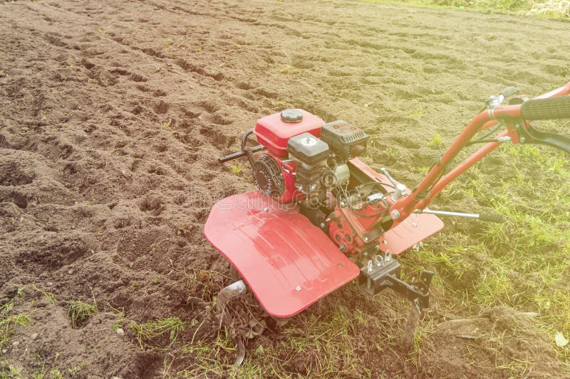 A Farmer Uses a Red-colored Technique To Cultivate a Small Plot of Land ...