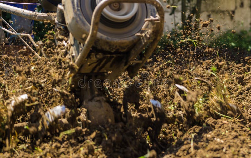 Farmer Using Machine Mart Cultivator for Ploughing Soil Stock Photo ...