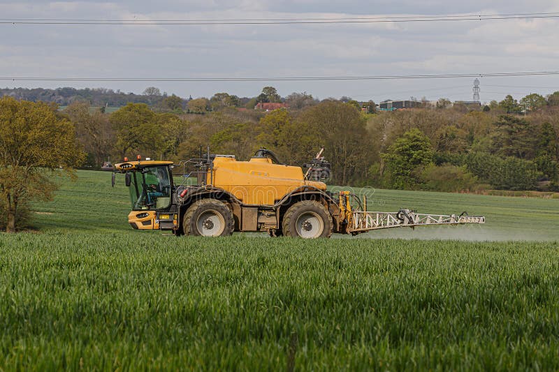 Farmer Using a Self Propelled Crop Sprayer in a Field in Early Spring ...