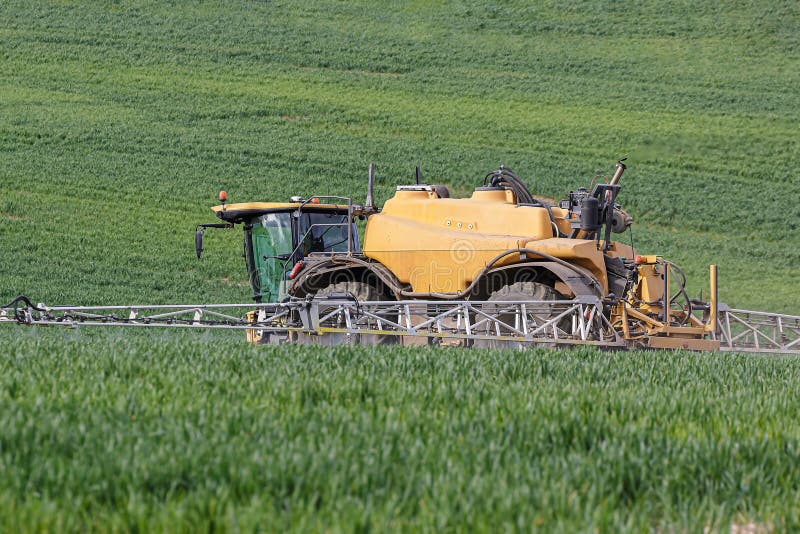 Farmer Using a Self Propelled Crop Sprayer in a Field in Early Spring ...