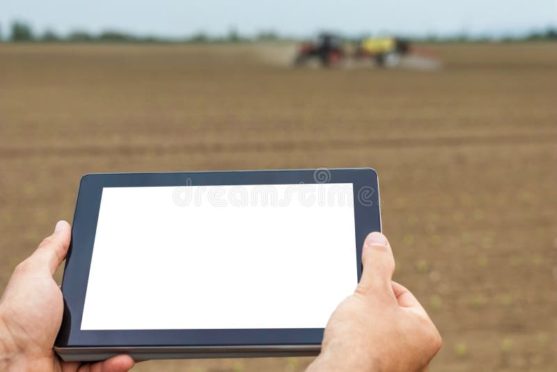 Farmer Using Tablet Computer in Agricultural Cultivated Field. W Stock ...