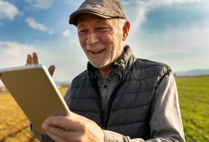 Farmer Using Tablet for Video Call in Field Stock Photo - Image of ...