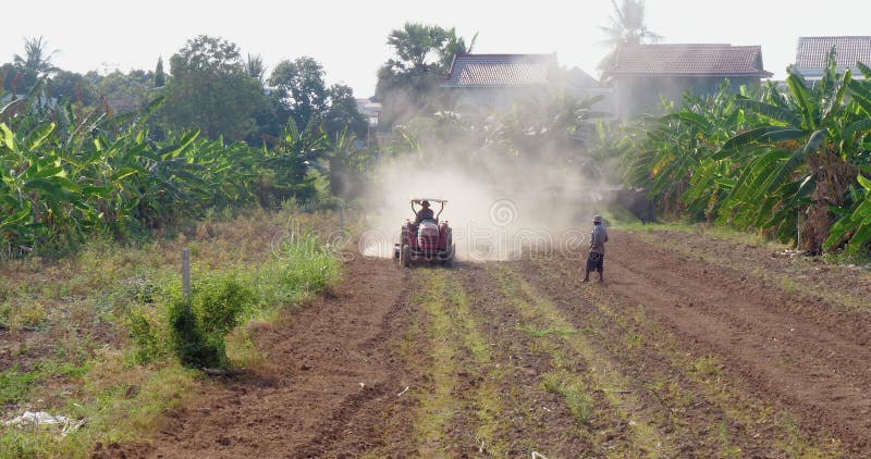 Farmer Using a Tractor To Prepare the Land for Planting, Creating a ...