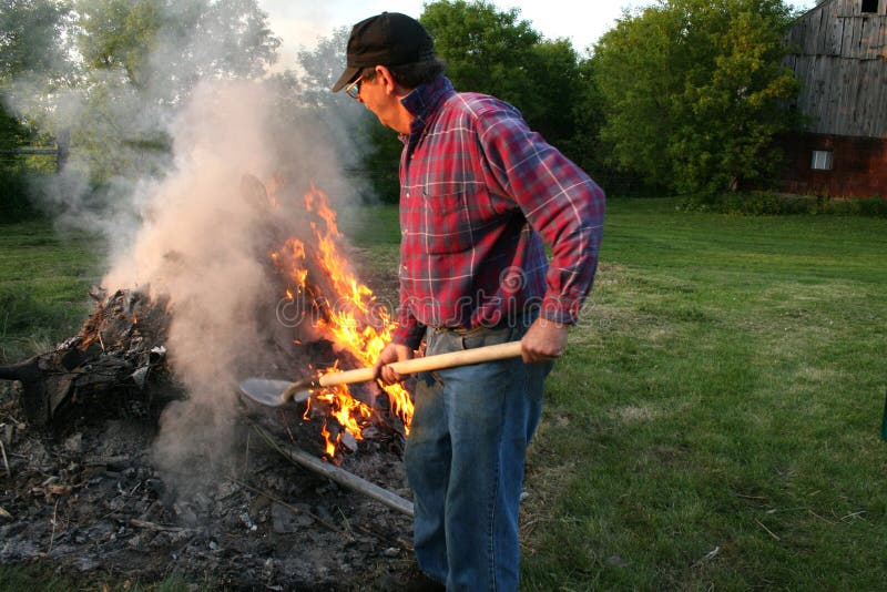Farmer Watching Over a Fire Stock Image - Image of stoking, sparks ...