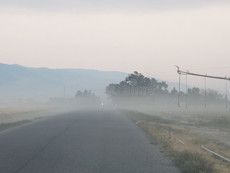 Farming dust across road stock image. Image of wind - 196794637