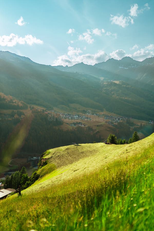 Farming Grass Field with a Tractor in a Mountain Landscape Stock Image ...