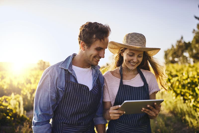 Farming Just Keeps on Getting Smarter. a Young Man and Woman Using a ...