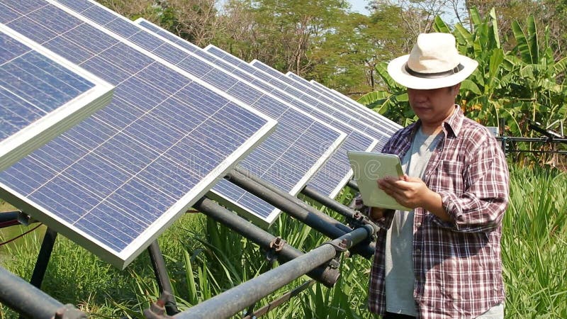 Farming Man Holding a Tablet Used To Control Solar Panels, Solar Power ...