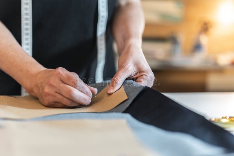 Fashion Designer Putting Pins into Pattern and Fabric Stock Image ...