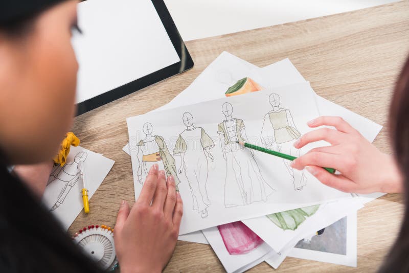 Fashion Designers Working with Blueprints of Models at Table Stock ...