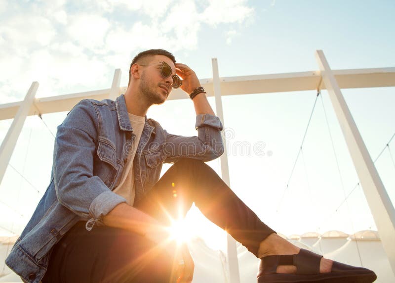 Fashion Guy Sitting at Sunset Posing in Sun Glasses Stock Image - Image ...
