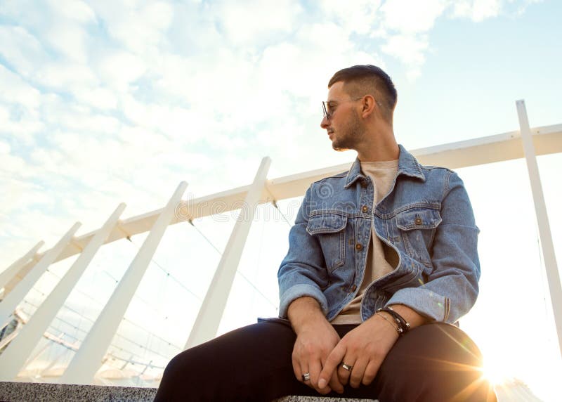 Fashion Guy Sitting at Sunset Posing in Sun Glasses Stock Photo - Image ...