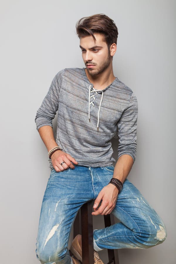 Fashion Man Looking Down while Sitting on a Stool Stock Image - Image ... Fashion Man Looking Down while Sitting on a Stool Stock Image - Image ...