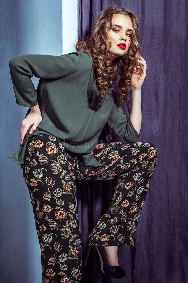 Fashion Model with Makeup and Wavy Hairstyle is Posing in Fitting Room ...