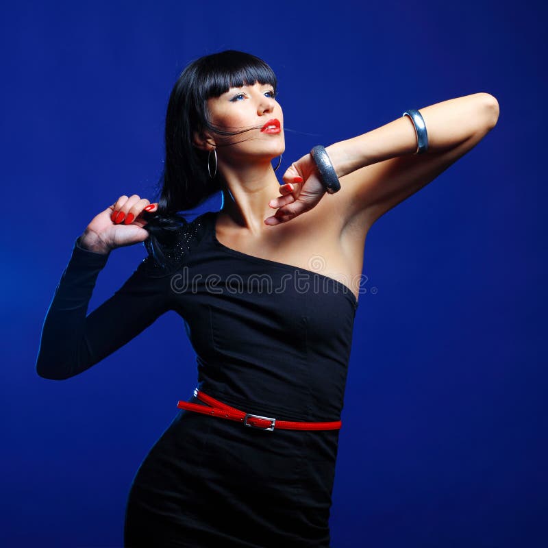 Fashion Model Posing in Studio on a Dark Blue Background Stock Image ...