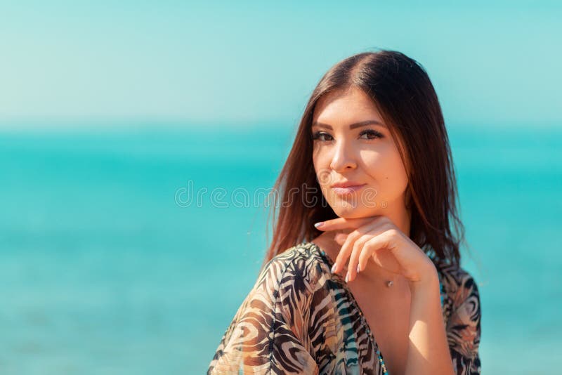 Fashion Portrait Of A Beautiful Tanned Woman On The Background Of The