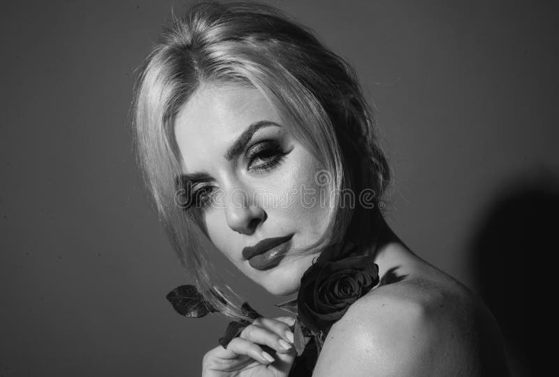 Fashion Portrait Of Young Beautiful Woman With Blue Eyes And Red Rose