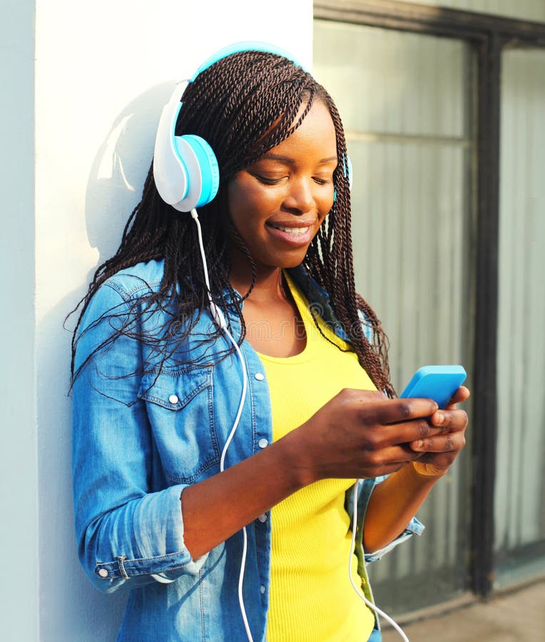 Fashion Pretty Smiling African Woman With Headphones Listens To Music