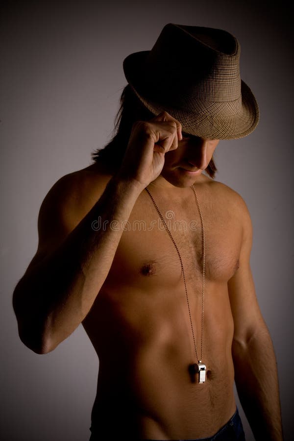 Muscular Handsome Man Posing in a Cowboy Hat and Jeans Over the Stock ...