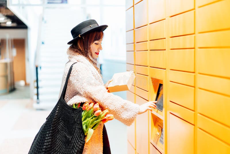 Fashion Woman with Box Using Modern Postal Automatic Mail Terminal with ...