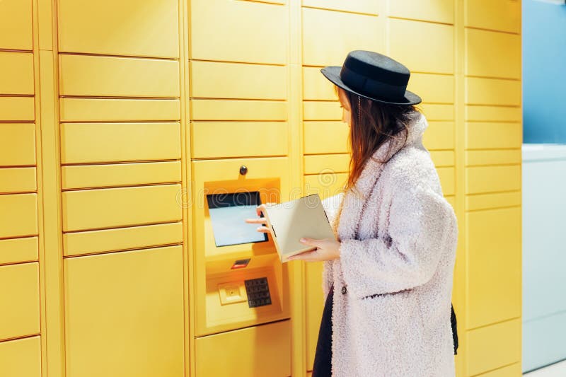 Fashion Woman with Box Using Modern Postal Automatic Mail Terminal with ...