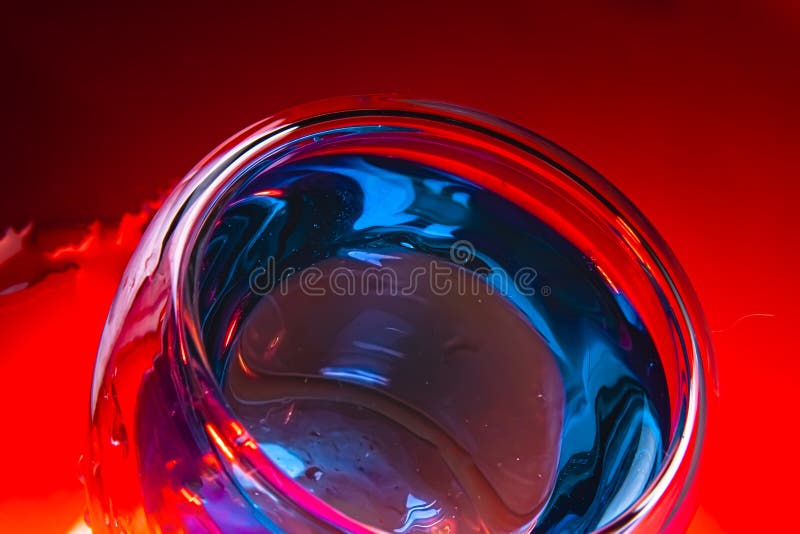 Fashionable Double Bottom Cup with Blue Liquid on Red Backround ...