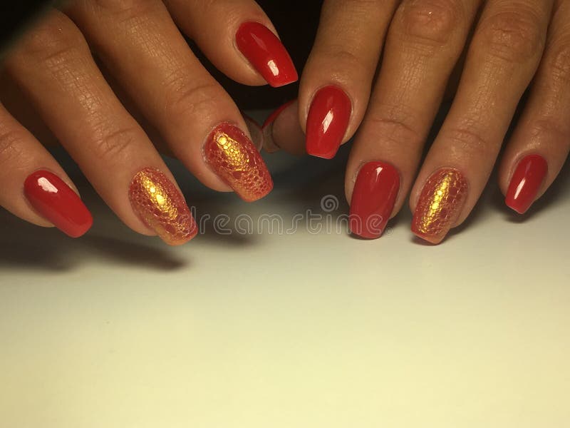 Fashionable Red Manicure with Golden Ruby Design on Long Nails Stock ...