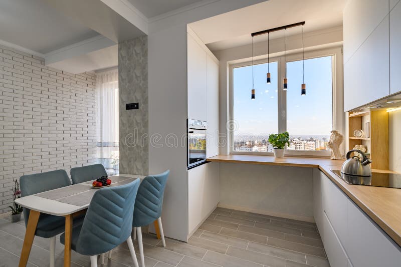 A Fashionable White Studio Apartment with a Fully-stocked Kitchen Stock ...