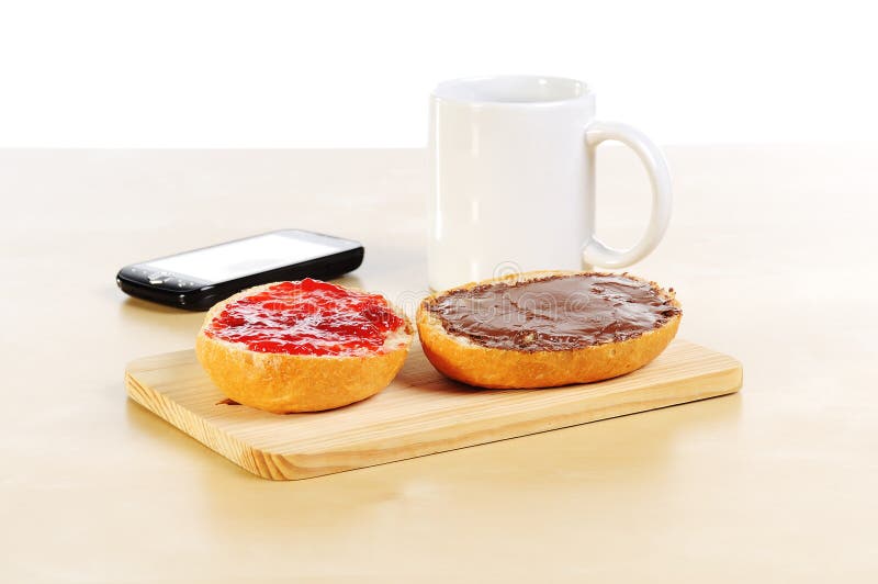 Fast Breakfast with Bread Roll Cup of Coffee and Mobile Phone Stock ...
