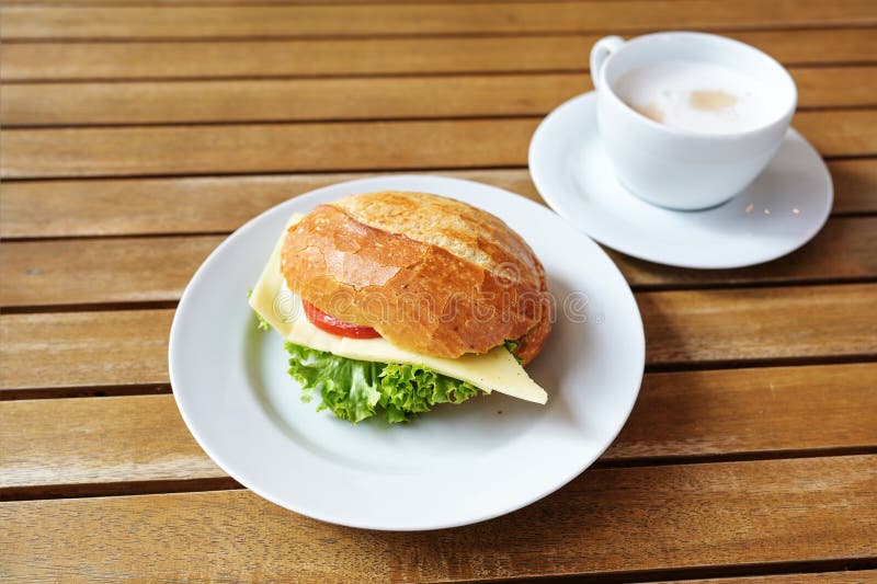 Fast Breakfast in a Cafe, Bread Roll with Cheese, Lettuce and Tomato ...