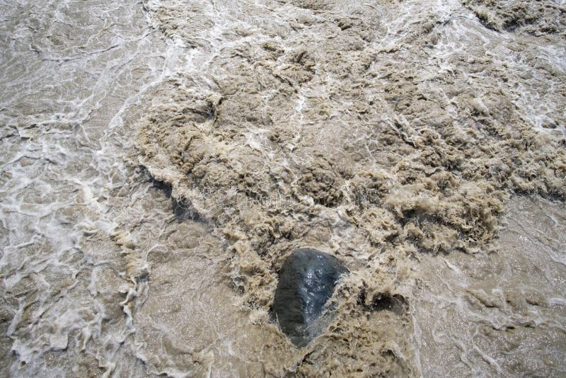 Flowing Muddied Water Around the Rock Stock Photo - Image of rough ...