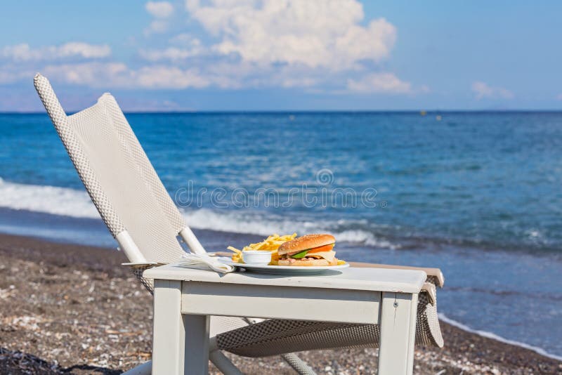 Fast food on the beach stock photo. Image of table, cheeseburger - 78632698
