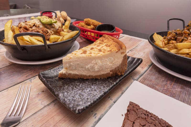 Fast Food Dishes and Snacks on a Table with Cheesecake Dessert Stock ...