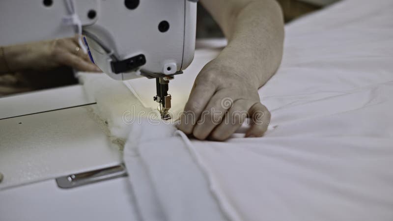 Fast Movement of the Sewing Machine Needle on the White Fabric. Media ...