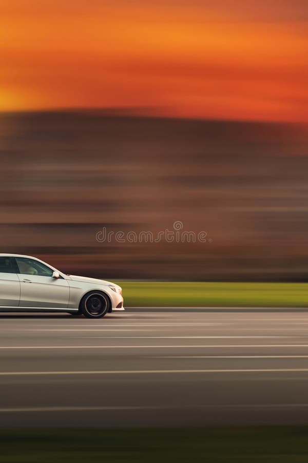 A Fast Moving Car. Car with Abstract Speed Blur Background in Evening ...