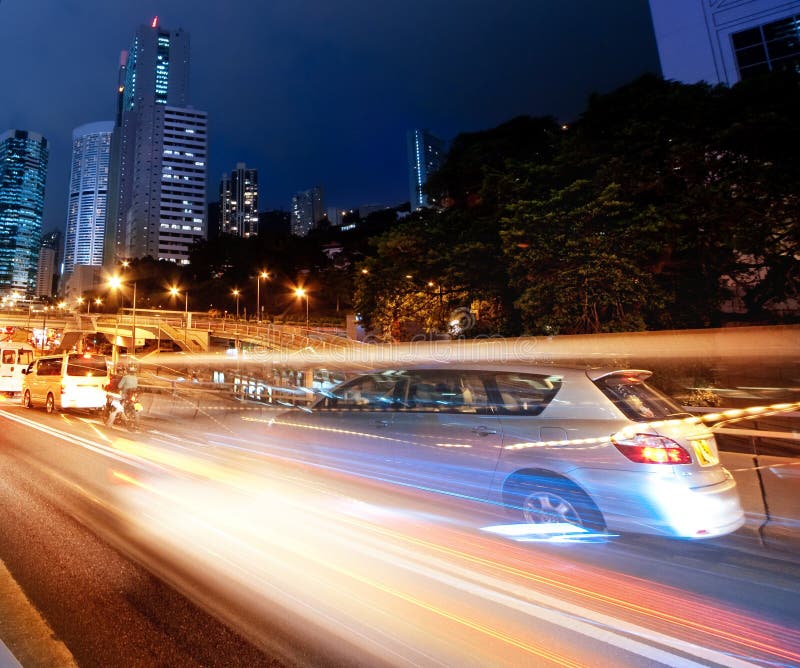 Fast moving cars at night stock image. Image of building - 12574505
