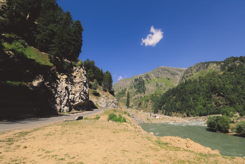 Fast River and Green Mountain Forest Under the Blue Sky in Gilgit ...