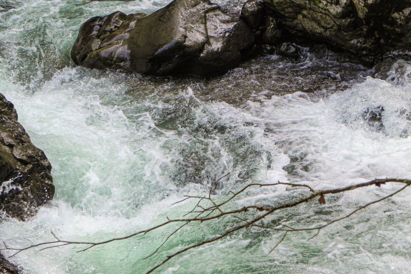 A Fast Small River Flows through Many Big Stones Stock Photo - Image of ...
