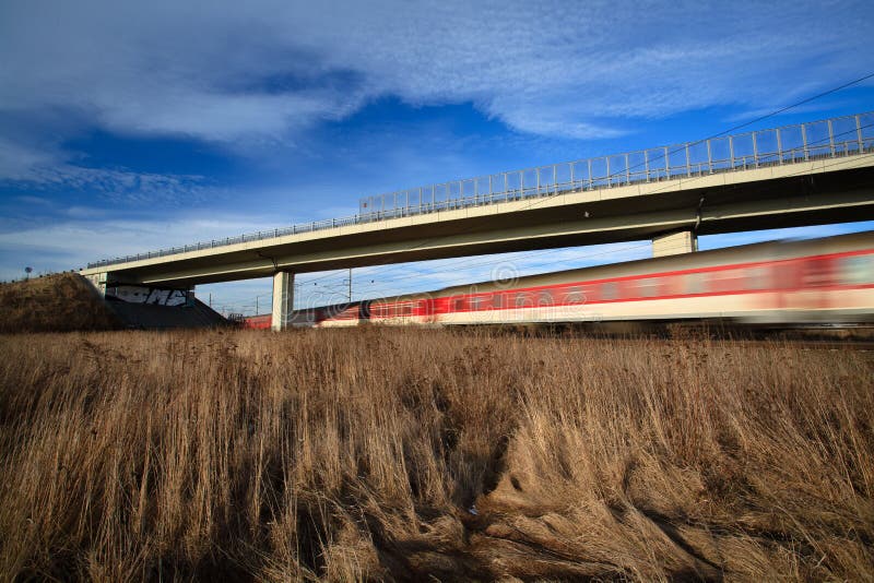 Fast Train Passing Under a Bridge on a Lovely Summer Day Stock Photo ...