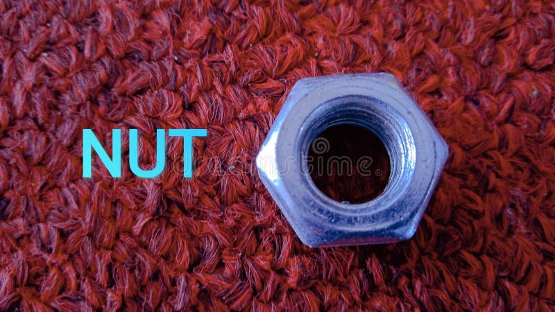 Fastener nut on red mat stock photo. Image of pattern - 270944042