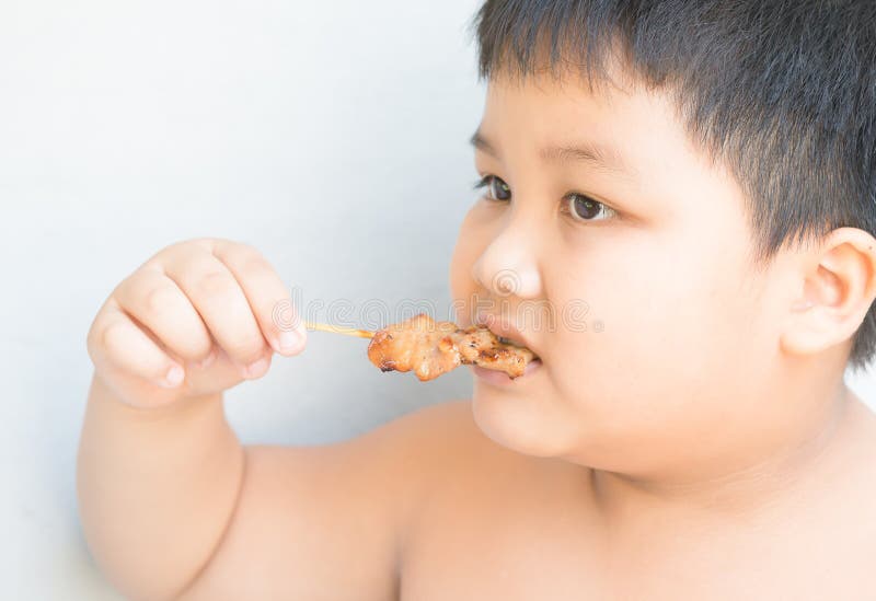 Fat boy eat grilled pork stock photo. Image of diet, pants - 59698438