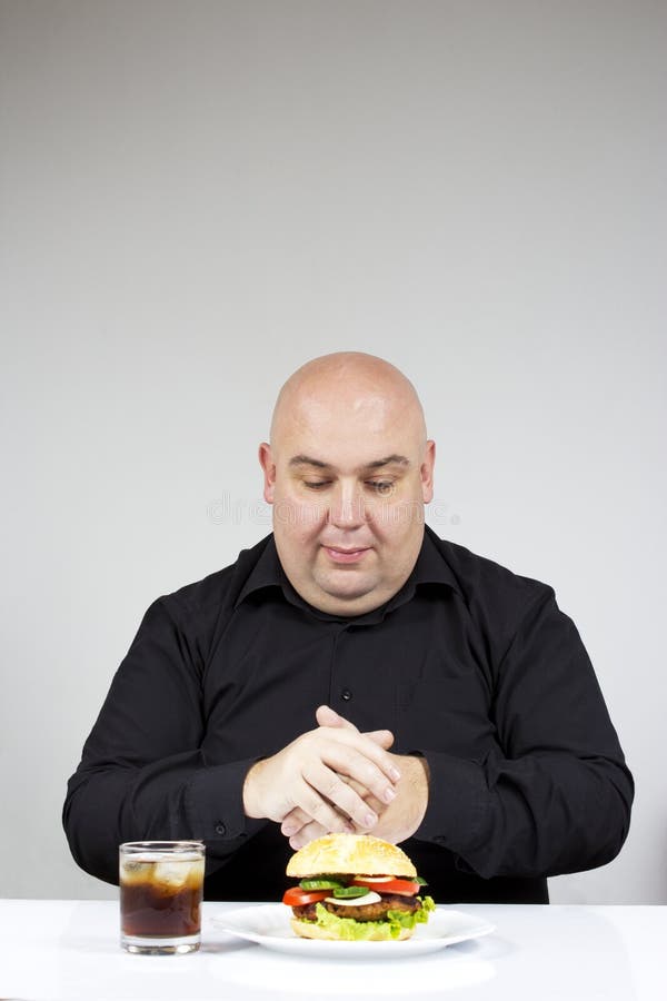 Fat man eating burger stock photo. Image of holding, junk - 29351808