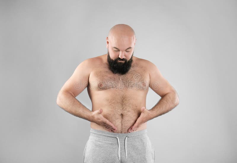 Fat man on grey background stock image. Image of overweight - 127819749