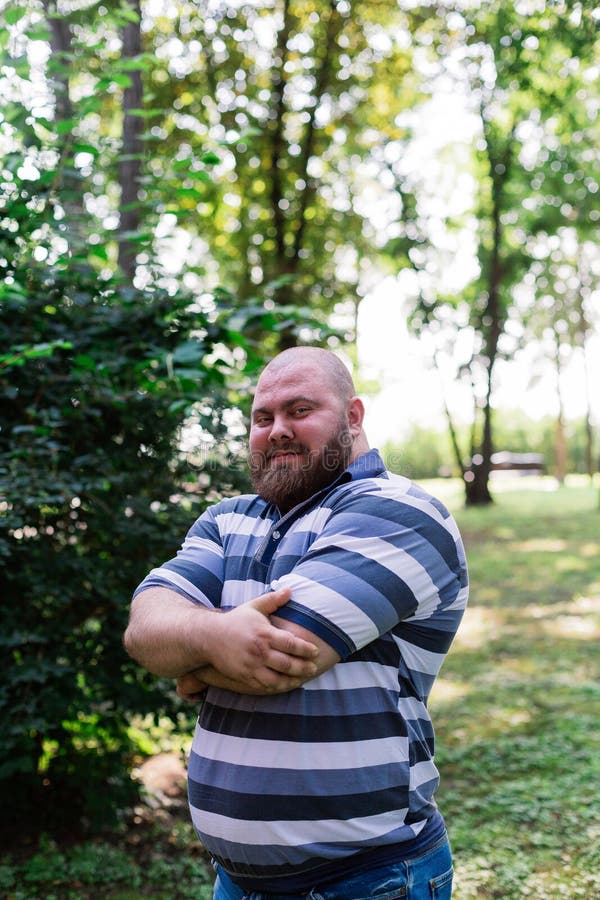 Fat Man in the Park Looks into the Frame, a Portrait of a Man with ...